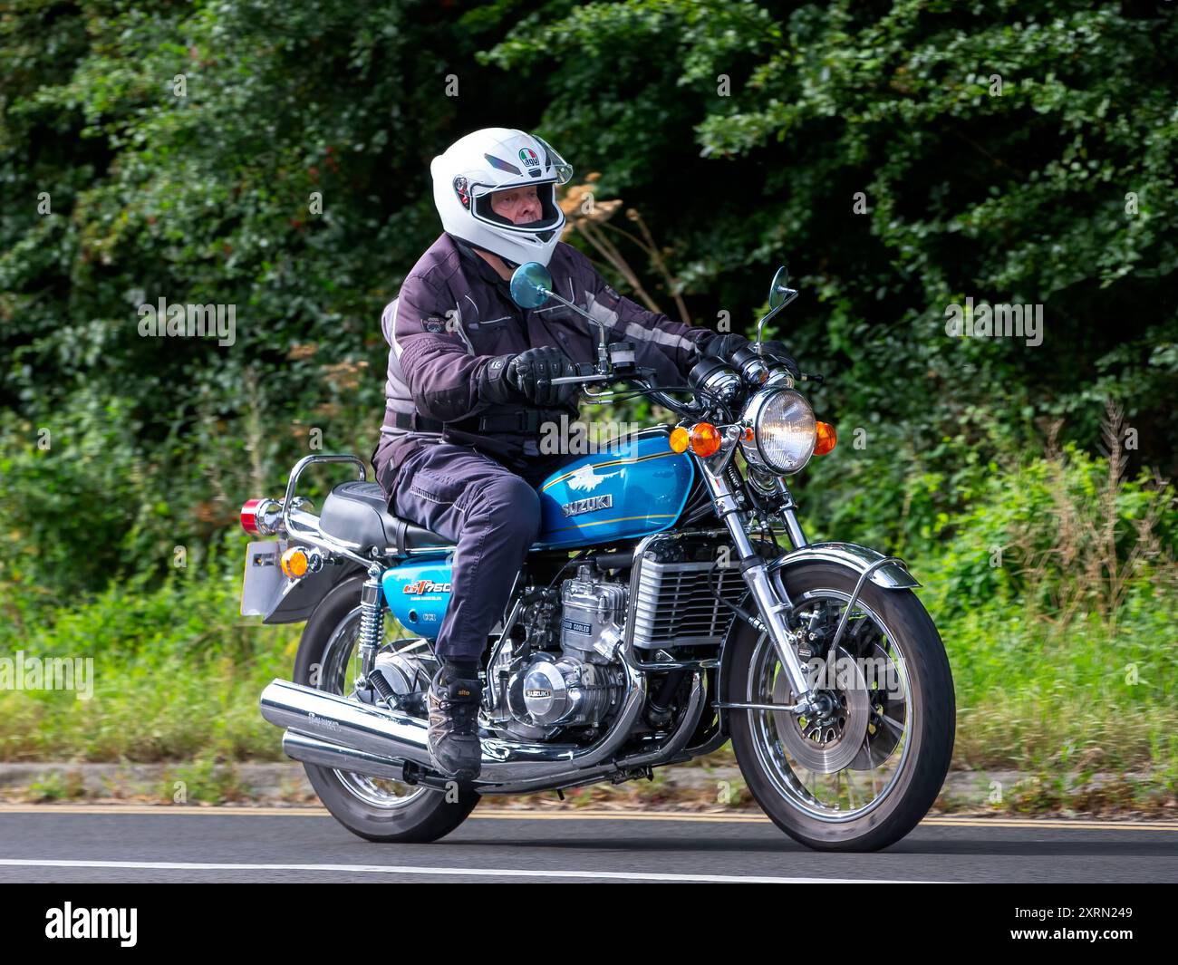 Potterspury,Northants,UK - Aug 11th 2024: Man riding a blue 1976 Suzuki ...