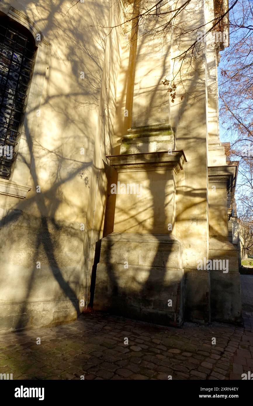 The sunlight creates intricate shadows on the foundation of the ...