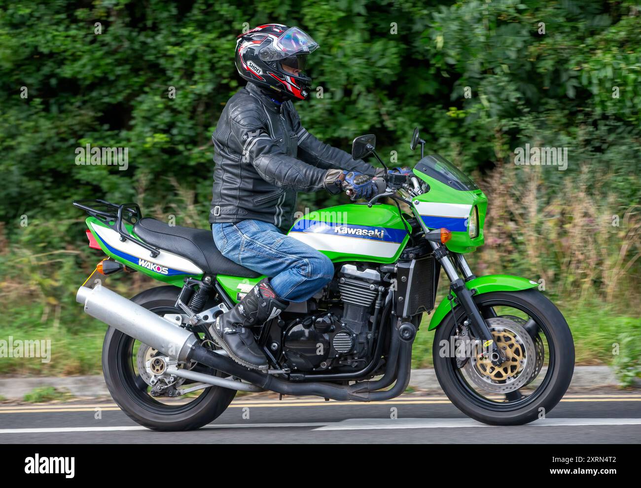 Potterspury,Northants,UK - Aug 11th 2024: Man riding a 1997 green ...