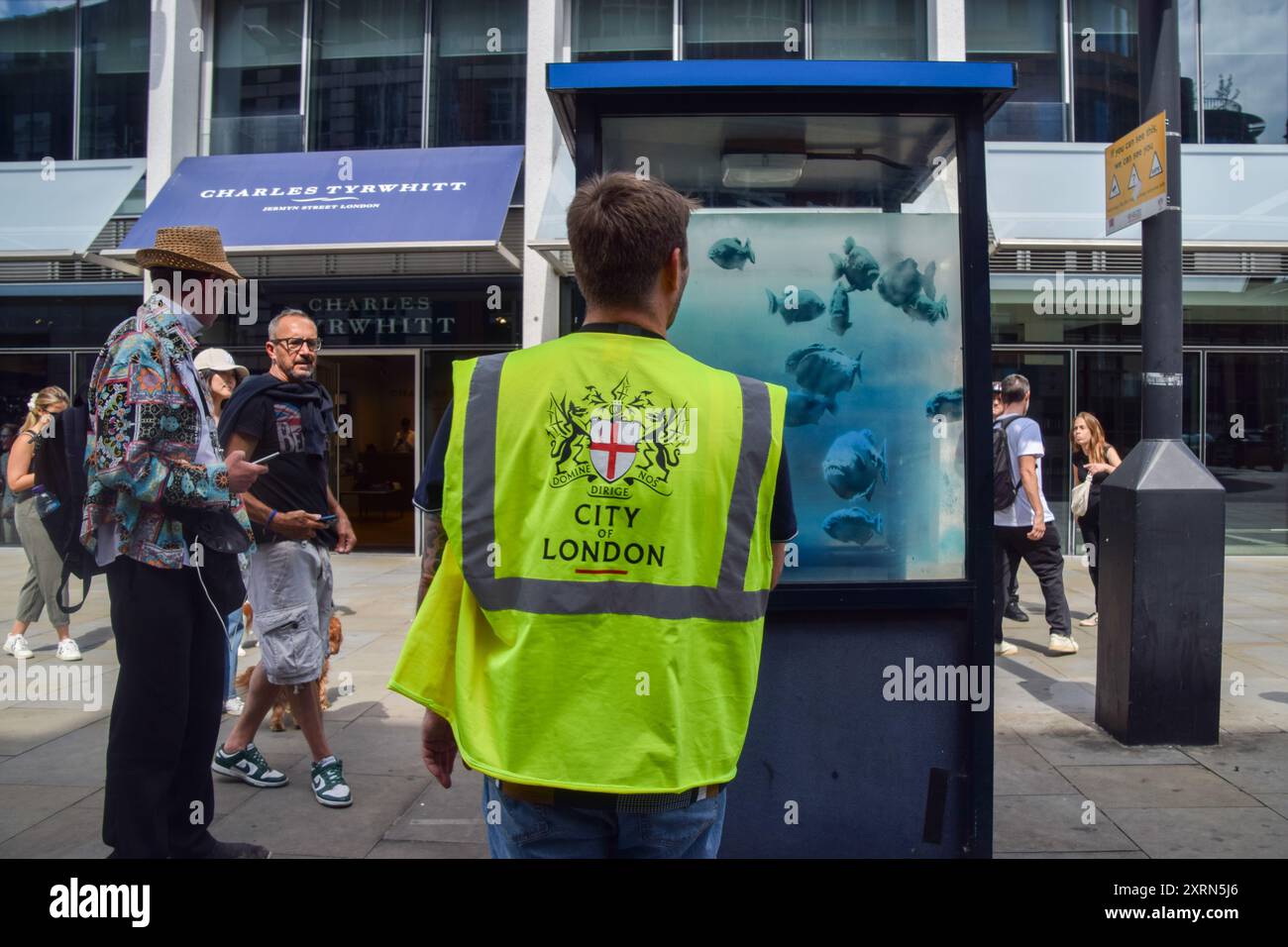 A worker inspects the police sentry box in the City of London with the ...