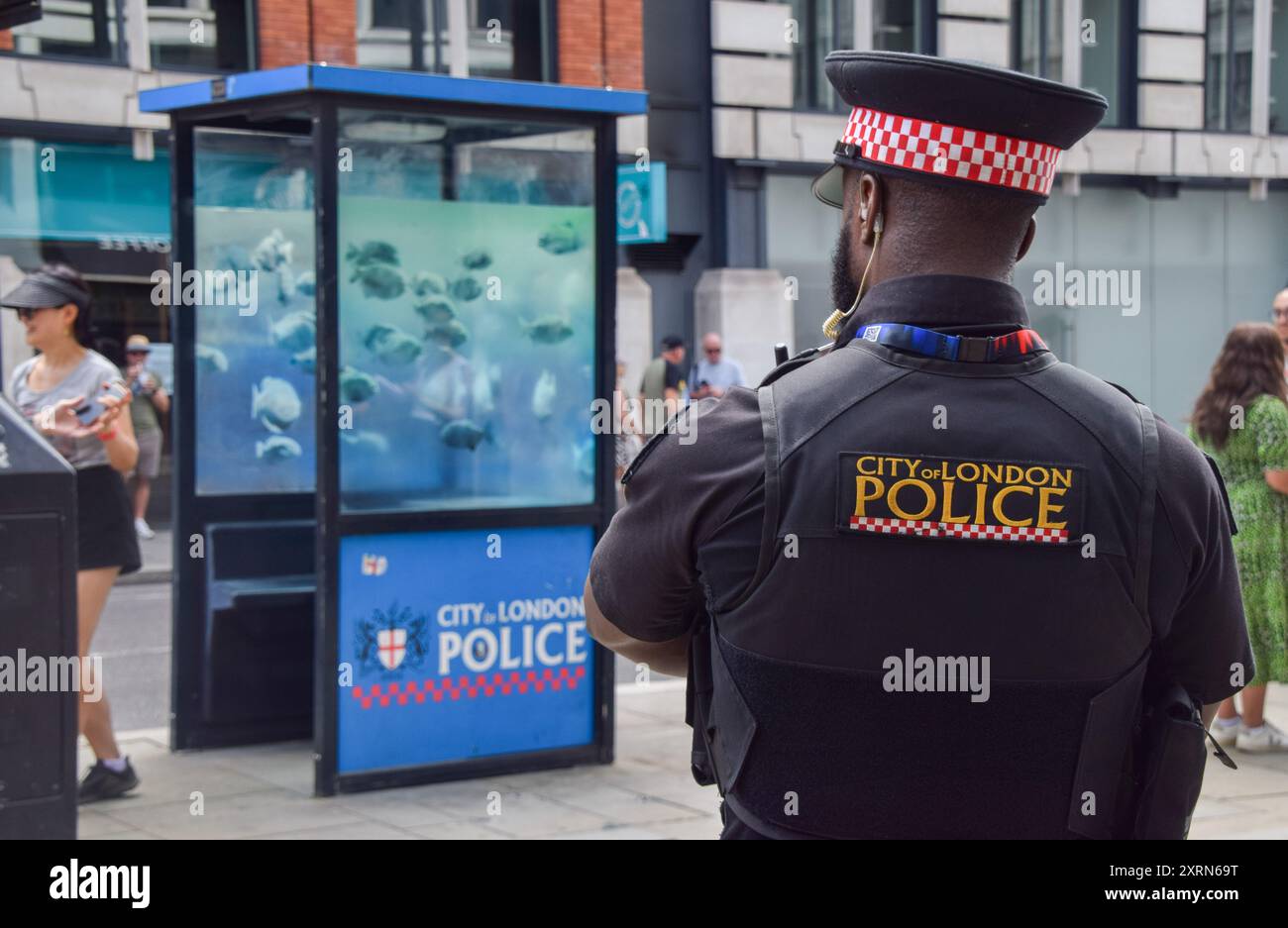 A police officer observes the crowds gathering around the police sentry ...