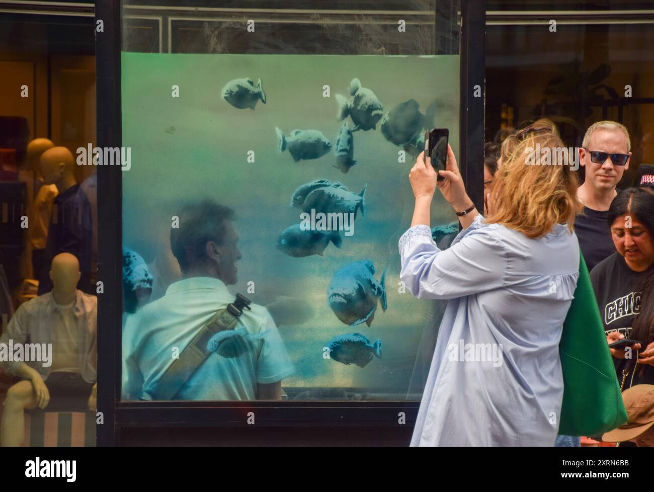 A woman takes photos of the police sentry box in the City of London ...