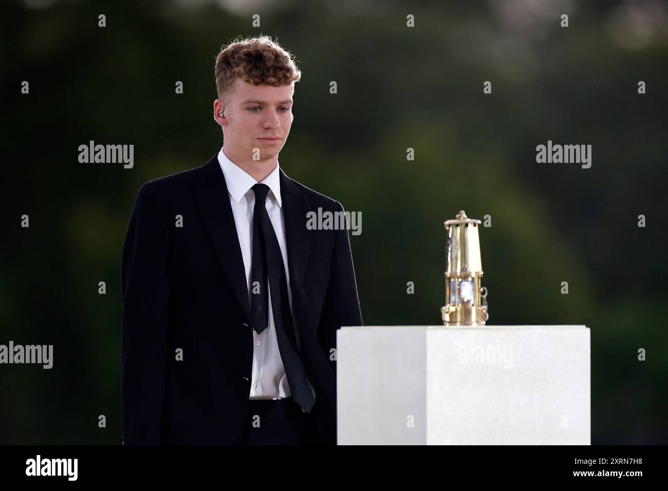 French swimmer Leon Marchand and the Olympic flame at the Gardens of ...