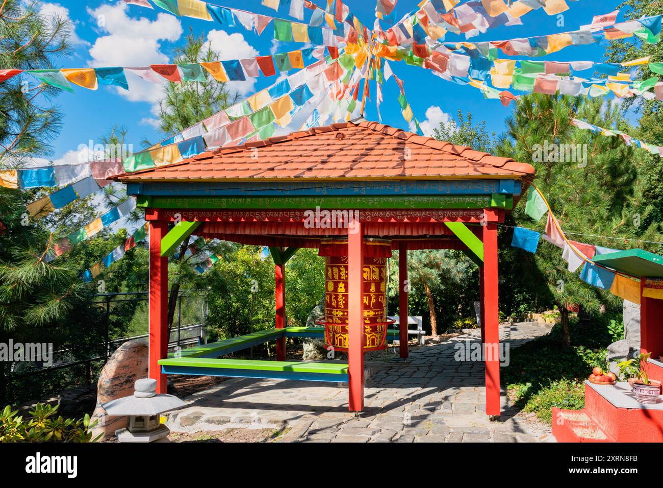 Buddhist prayer flags and red prayer wheel in the Grabensia Buddhist ...