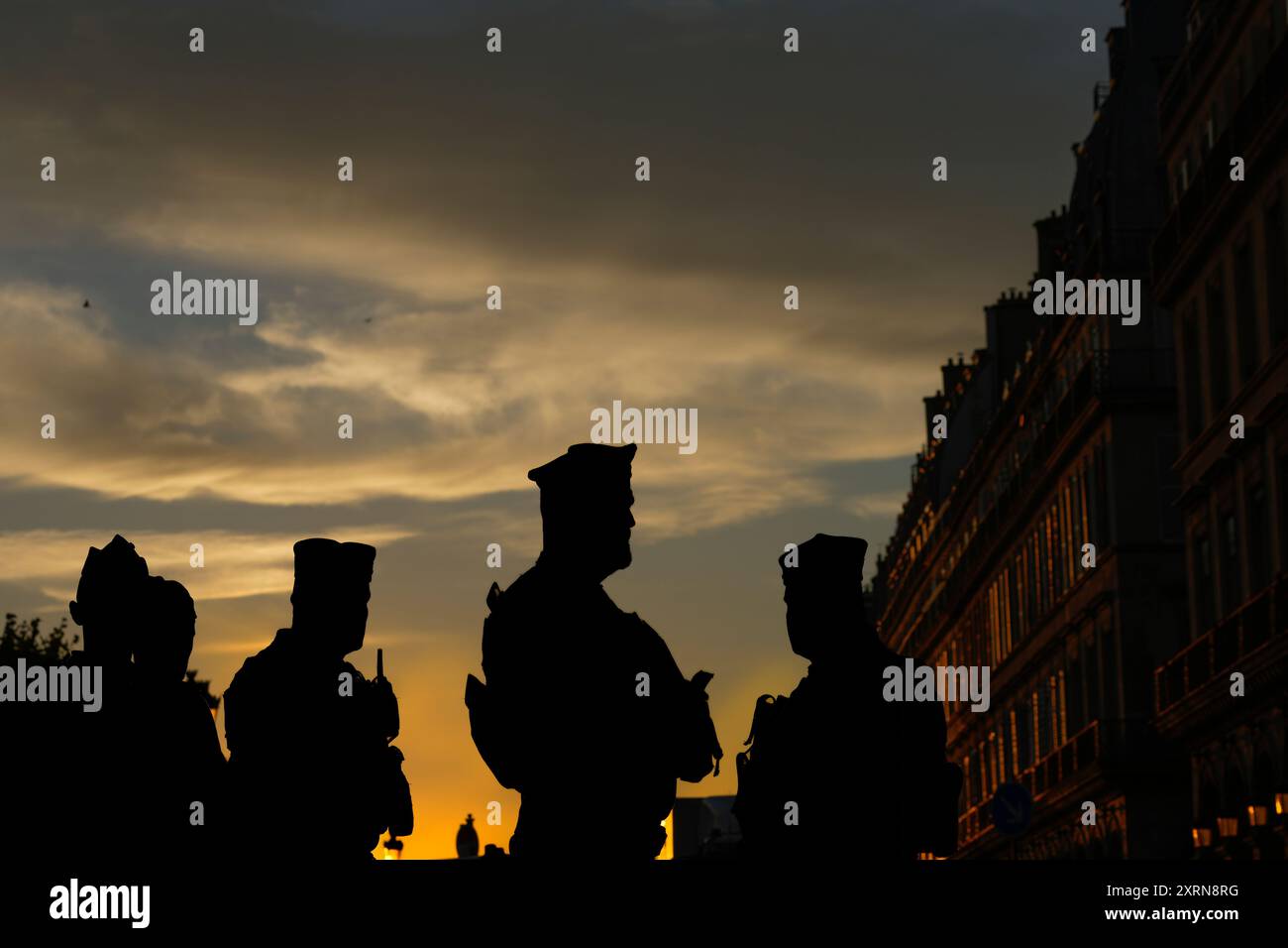 French police officers stand guard outside the Tuileries garden as the cauldron is extinguished ...