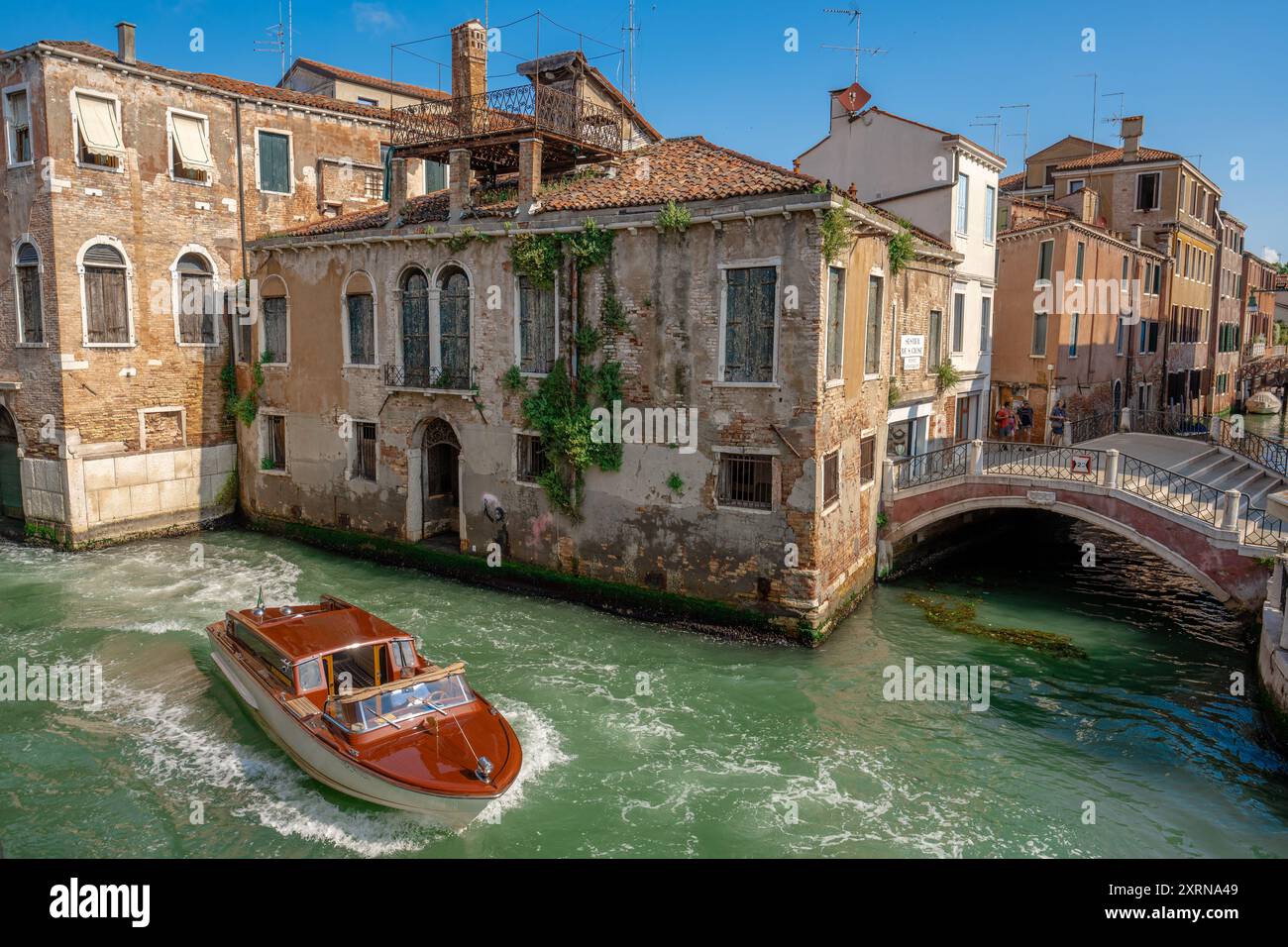 Venice, Italy - June 05, 2024: Orange boat in Venice canal. The Migrant ...