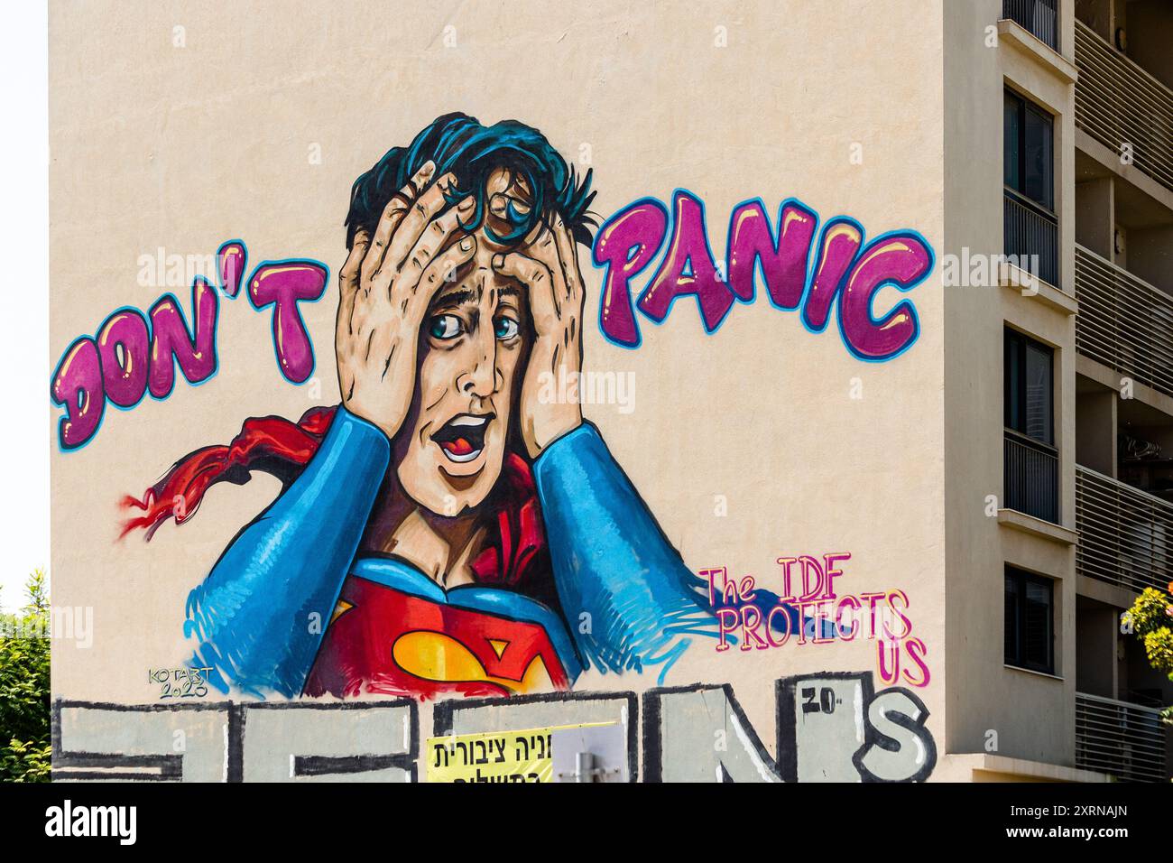 Graffiti with Superman on the street of Tel Aviv. Message says: "Dont' panic. The IDF protects ...