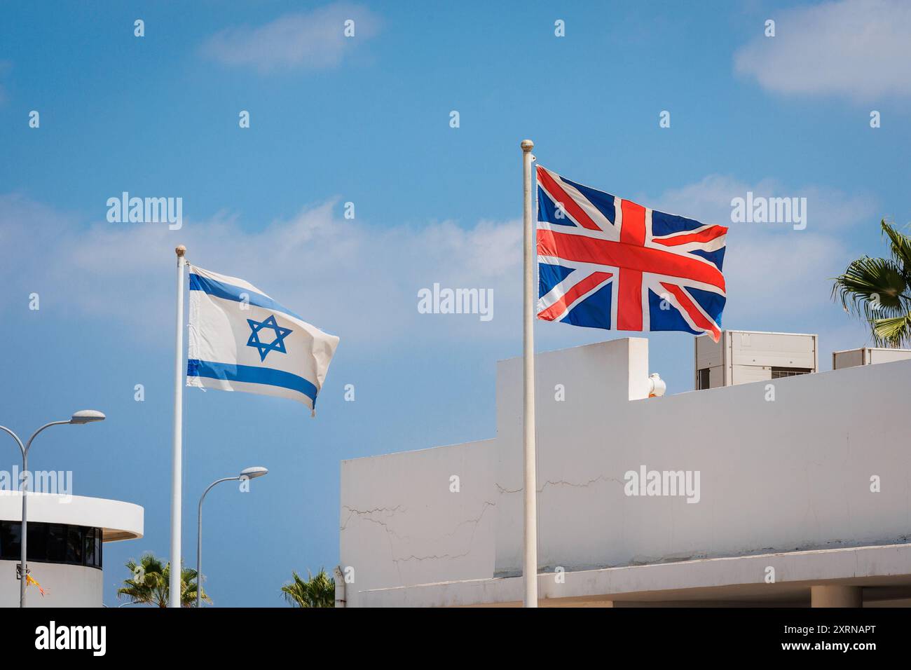 Flag of United Kingdom and Israeli flag flutter in the wind in Tel Aviv ...