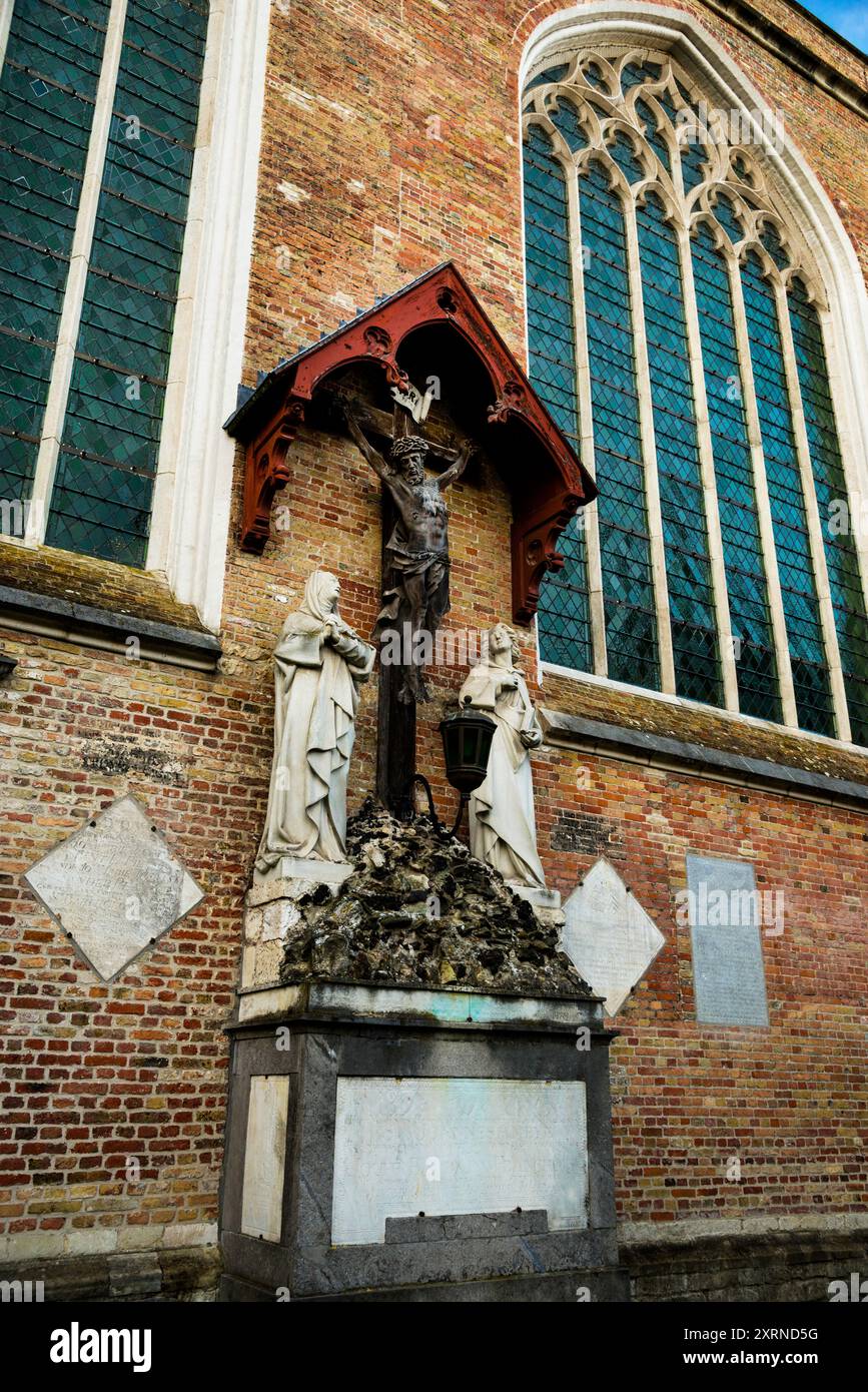 Statue of the crucifixion with Mary and Mary Magdalen in the garden of ...
