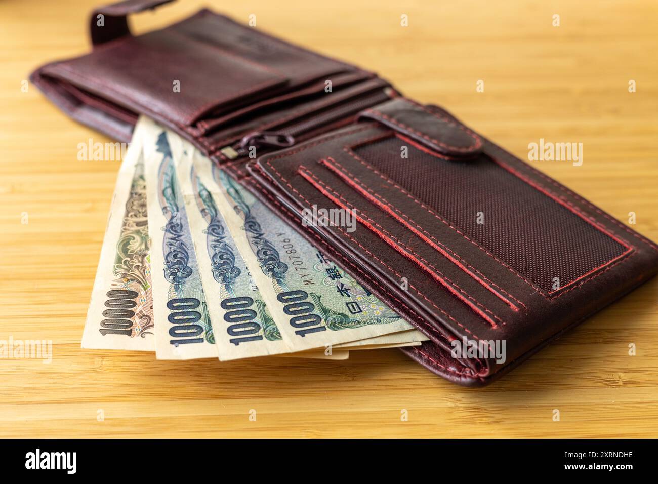 Japan money. Brown wallet with banknotes sticking out. Financial ...
