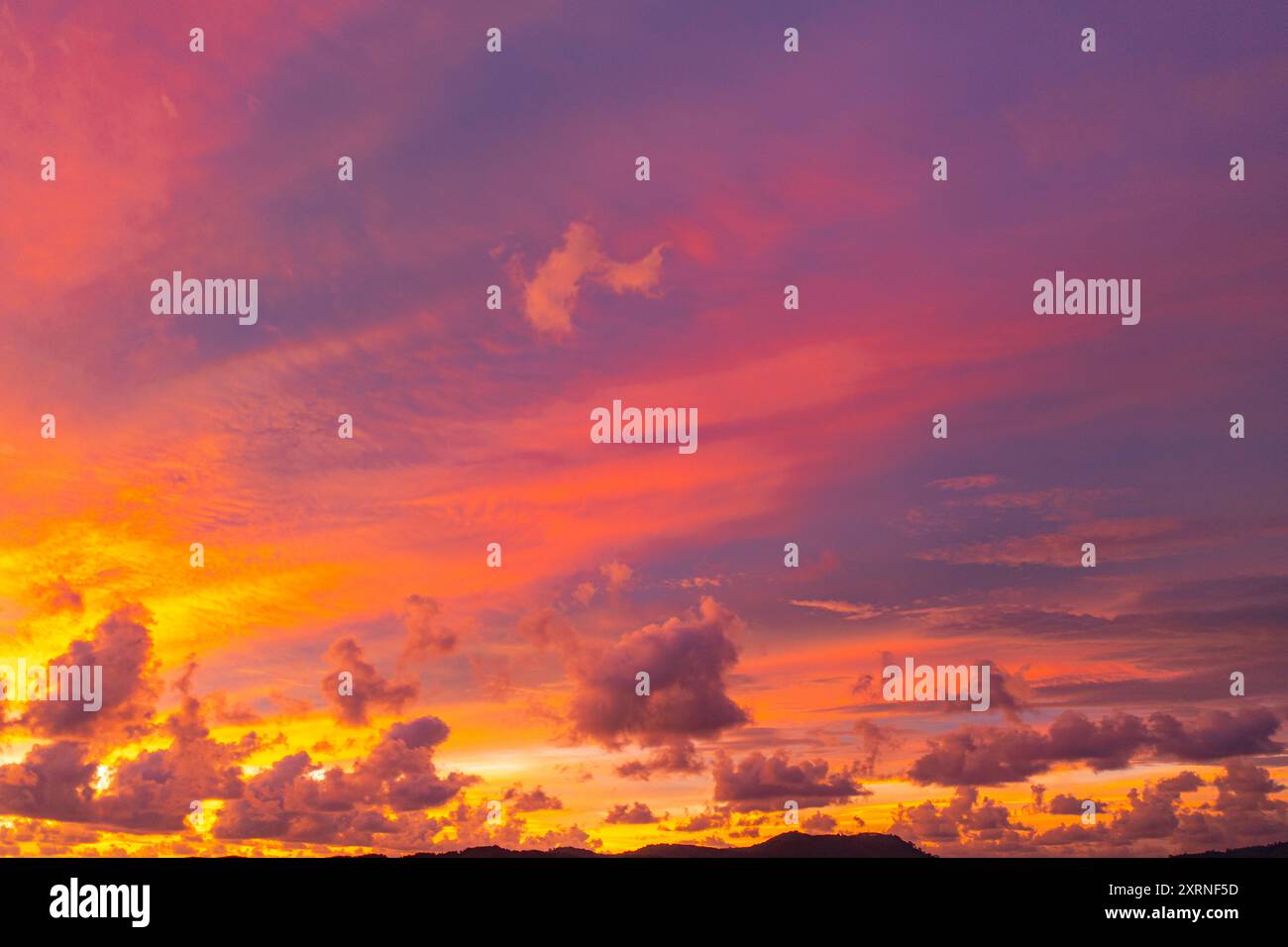 Aerial view of colorful sky at sunset while hints of gold radiate from ...