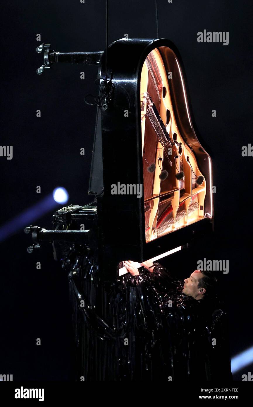 Paris, France. 11th Aug, 2024. Artist Alain Roche plays a piano during ...