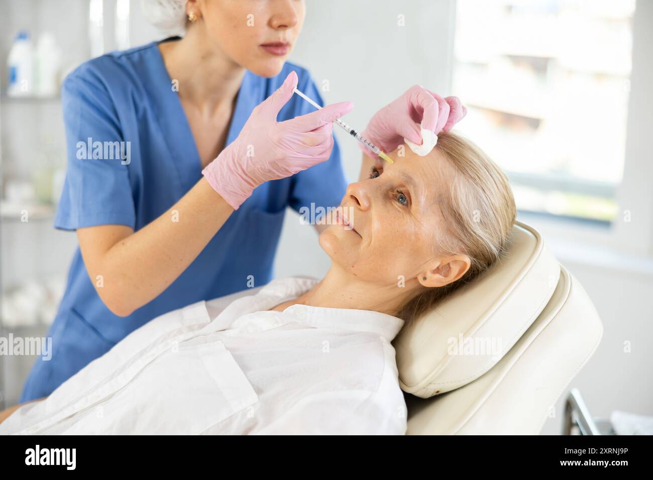 Woman having injection in the arm hi-res stock photography and images ...