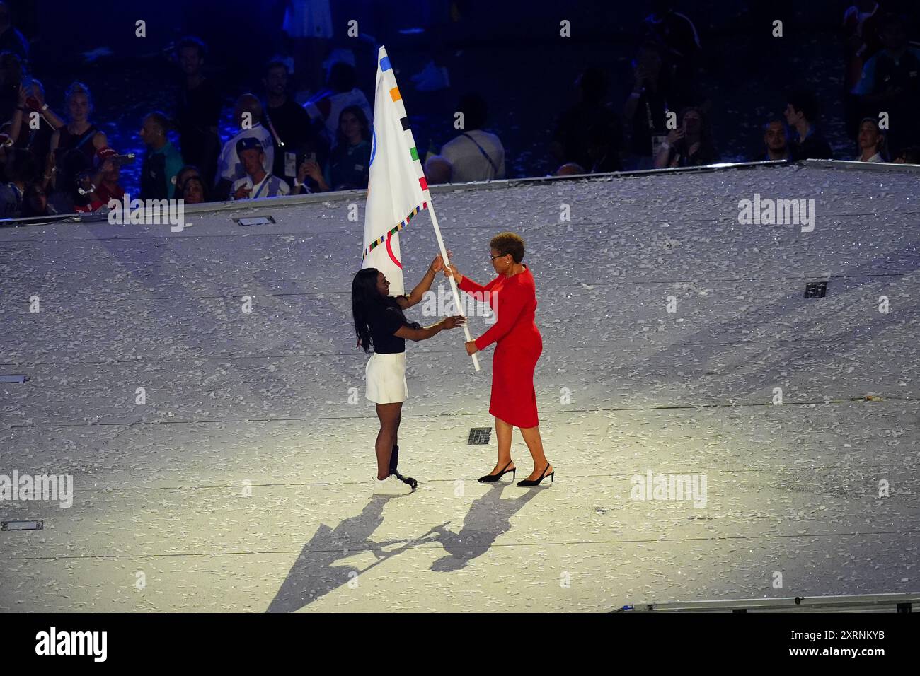 The Mayor of Los Angeles, Karen Bass (right) hands the Olympic flag to ...