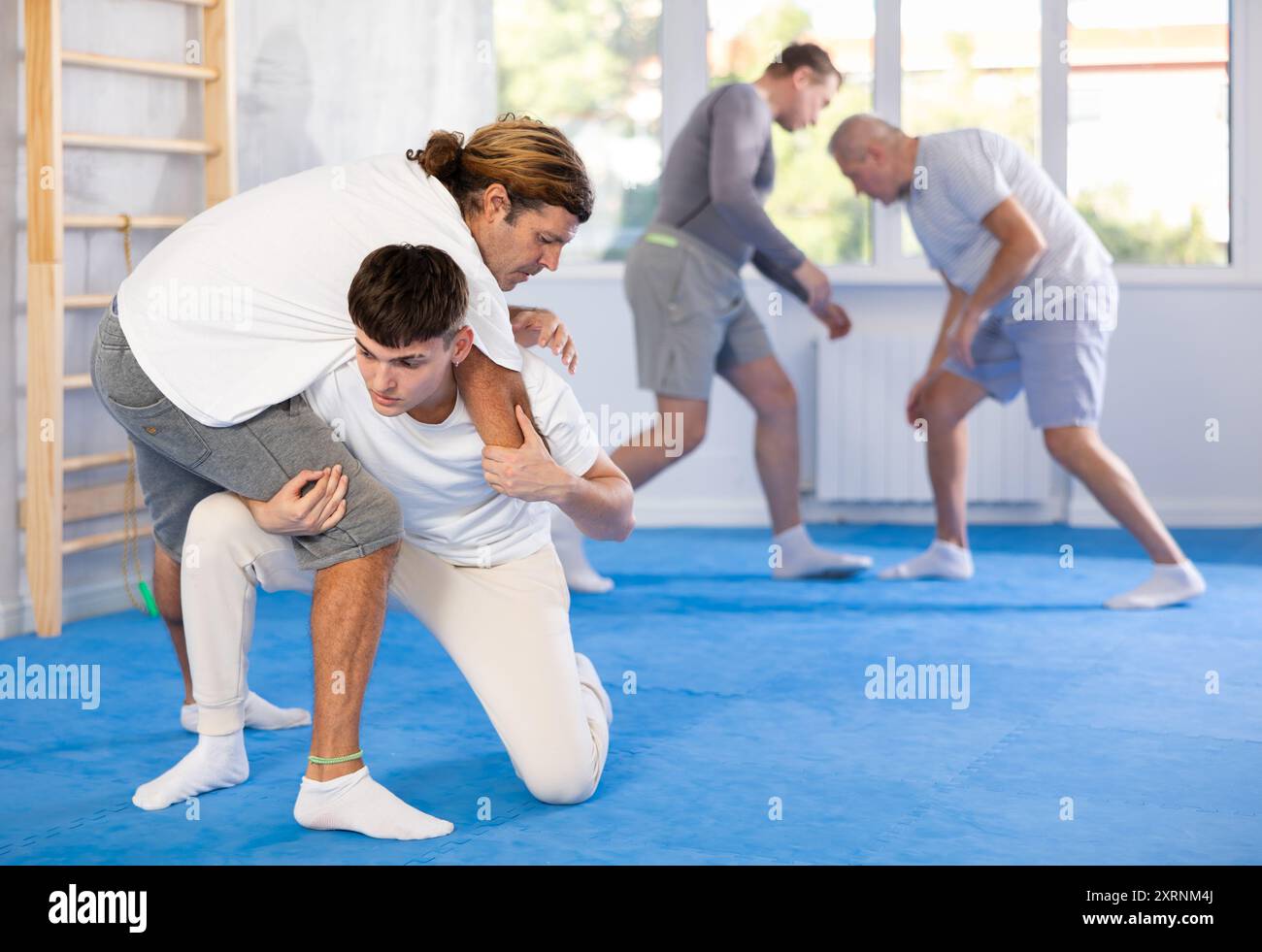 Judo lessons - young guy makes power throw during judo or sambo classes ...