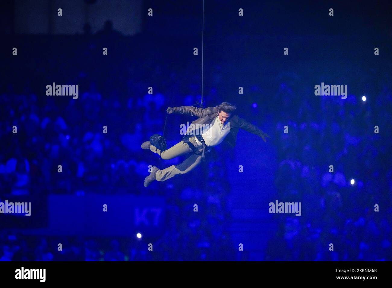 Tom Cruise is lowered on the Stade de France during the 2024 Summer ...