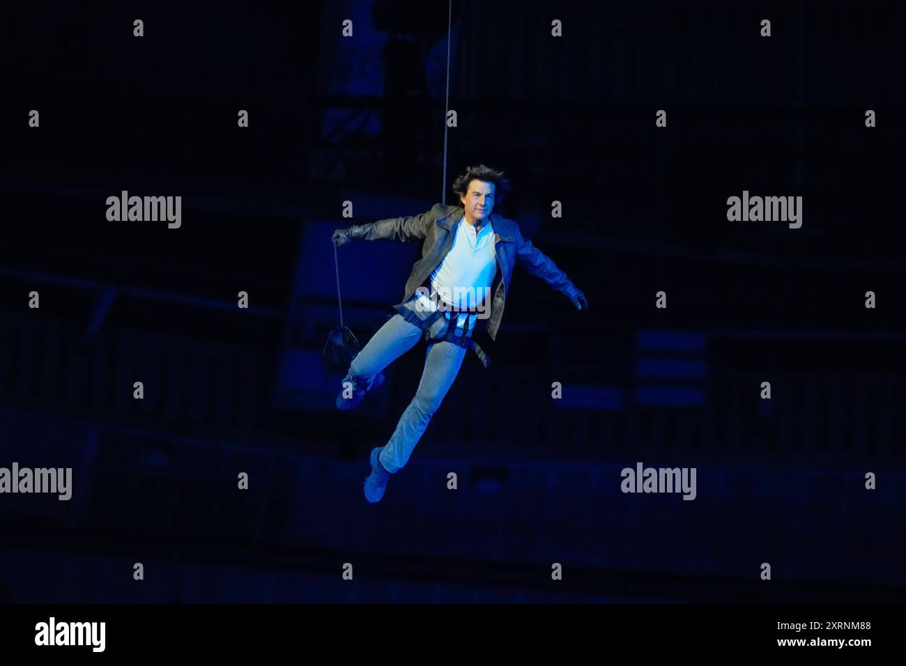 Tom Cruise is lowered on the Stade de France during the 2024 Summer ...