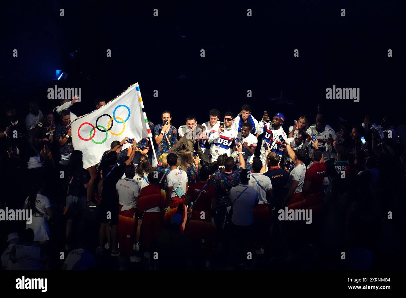 Tom Cruise leaves the stadium with the IOC flag during the closing ...