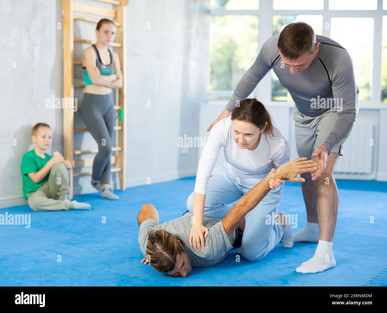 At self-defense training, trainer teaches woman technique of grabbing ...