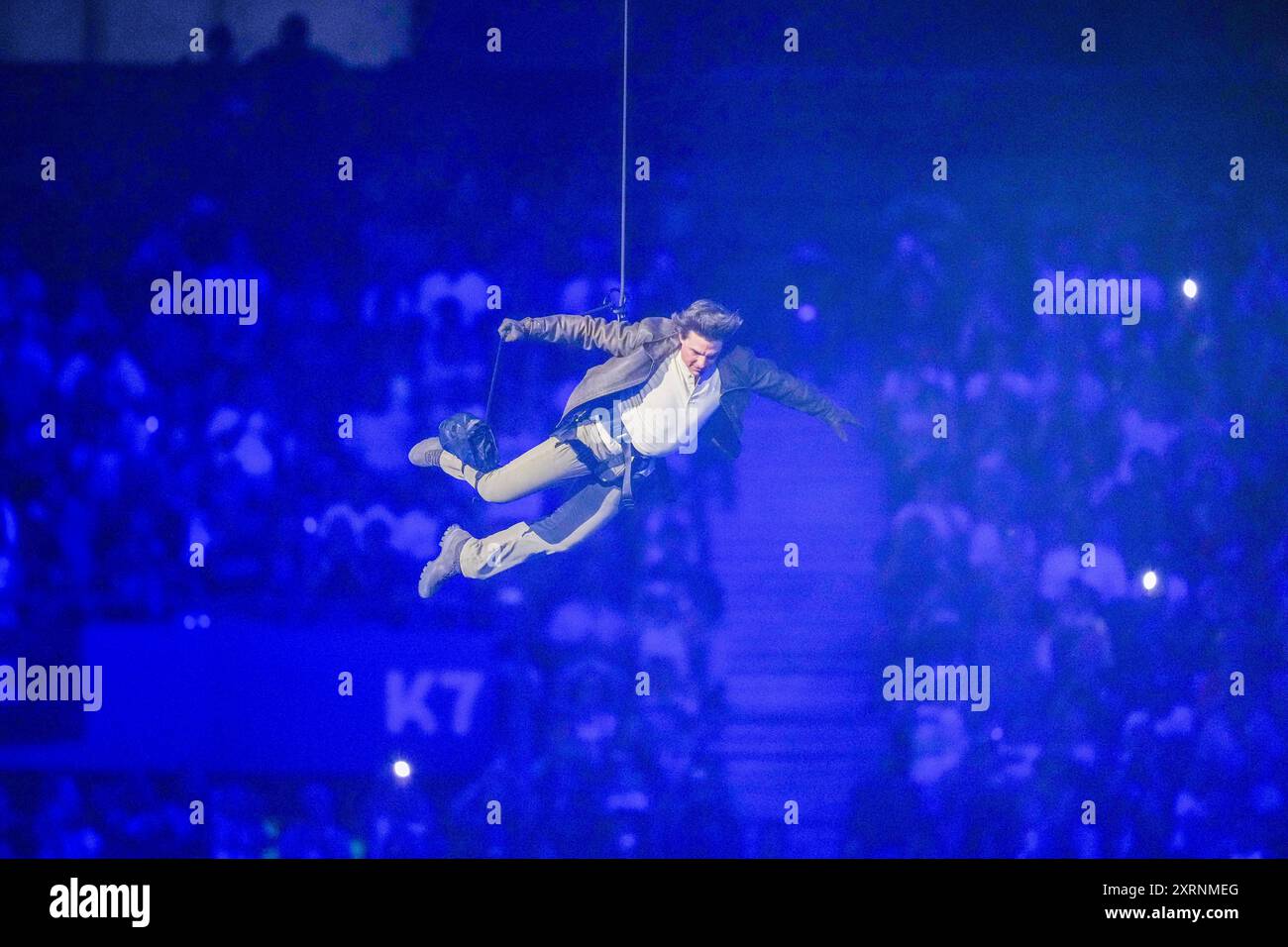 Tom Cruise is lowered on the Stade de France during the 2024 Summer ...