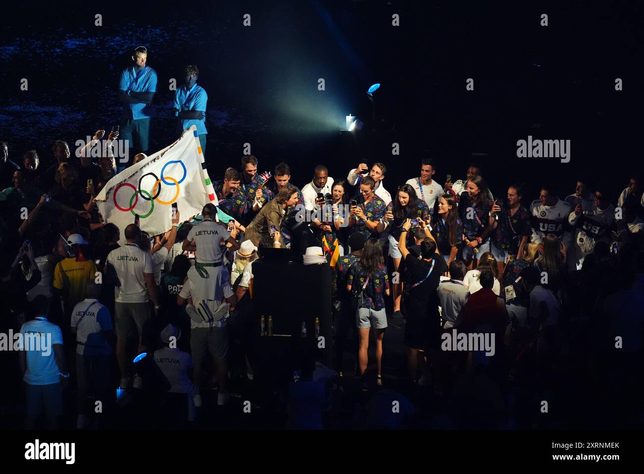 Tom Cruise leaves the stadium with the IOC flag during the closing ...