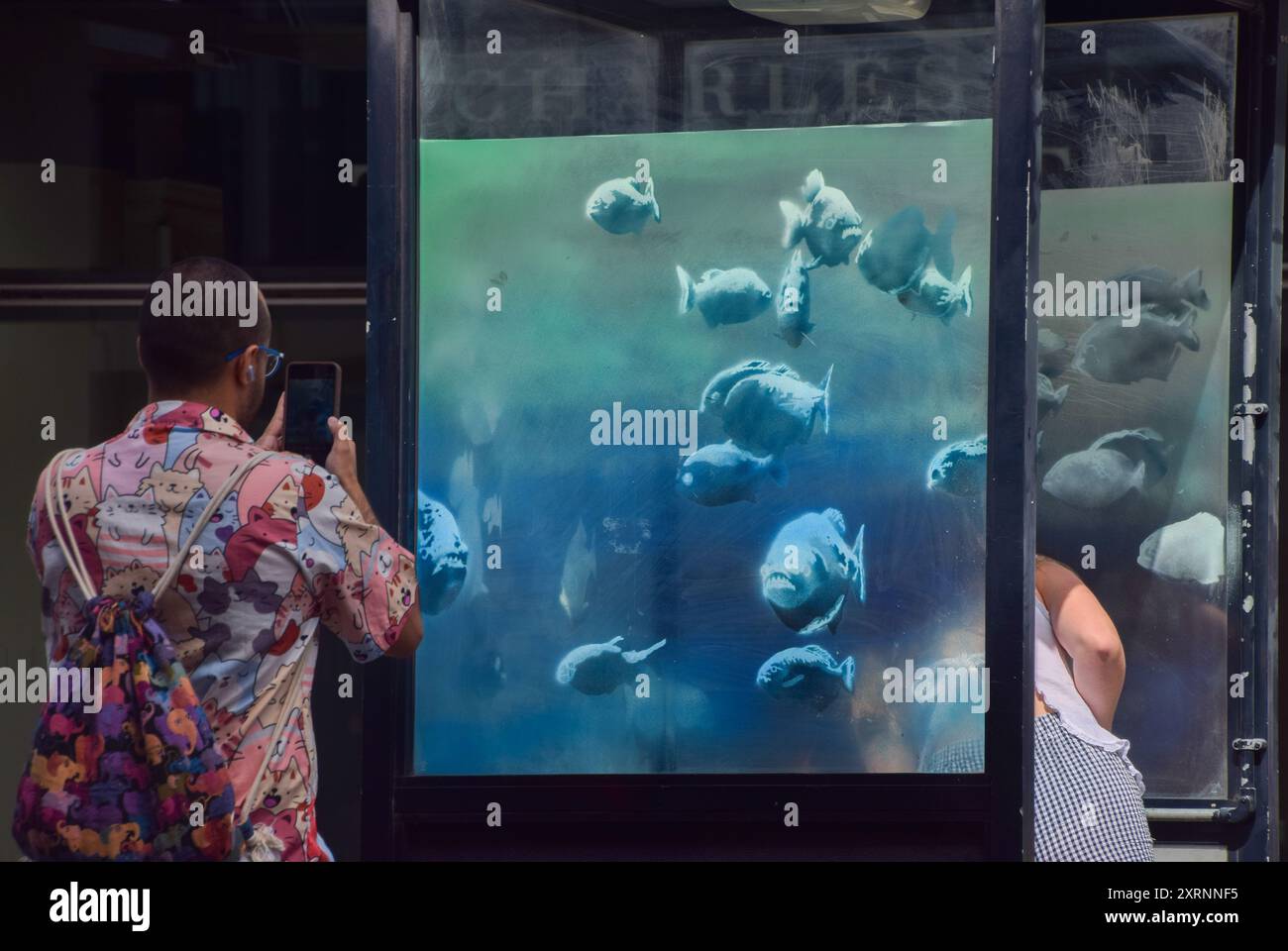 London, UK. 11th August 2024. A man takes photos of the police sentry ...