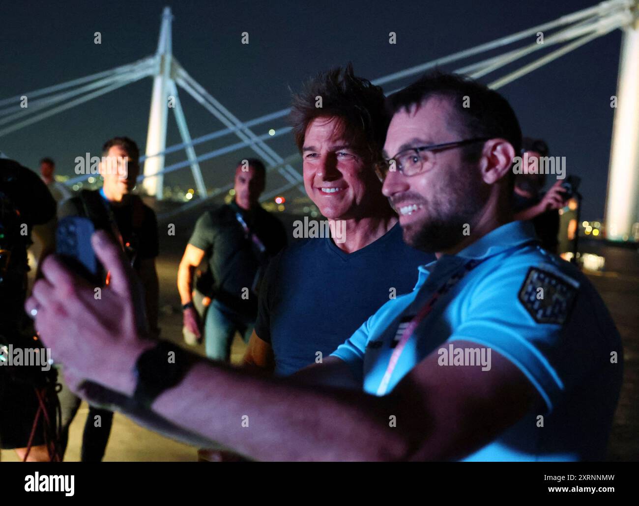 Actor Tom Cruise poses for a photo on the roof of the Stade de France ...