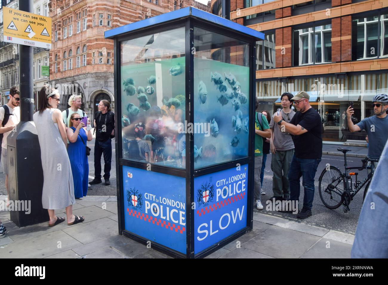 London, UK. 11th August 2024. People take photos of a new Banksy ...