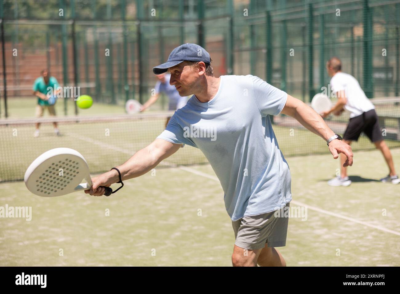 Male player serving ball during training padel in court Stock Photo - Alamy