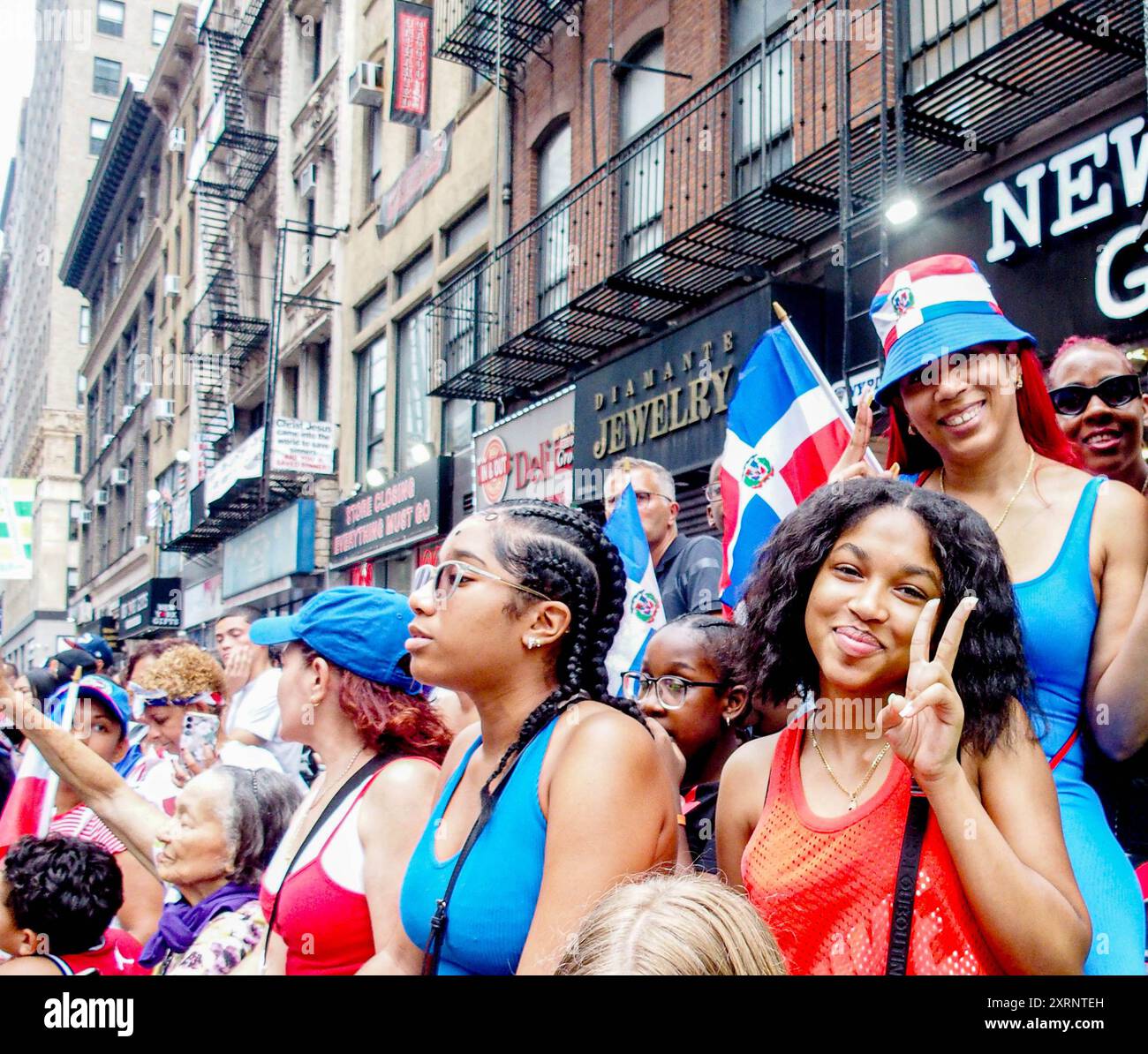New York, New York, USA. 11th Aug, 2024. A girl makes the peace sign ...