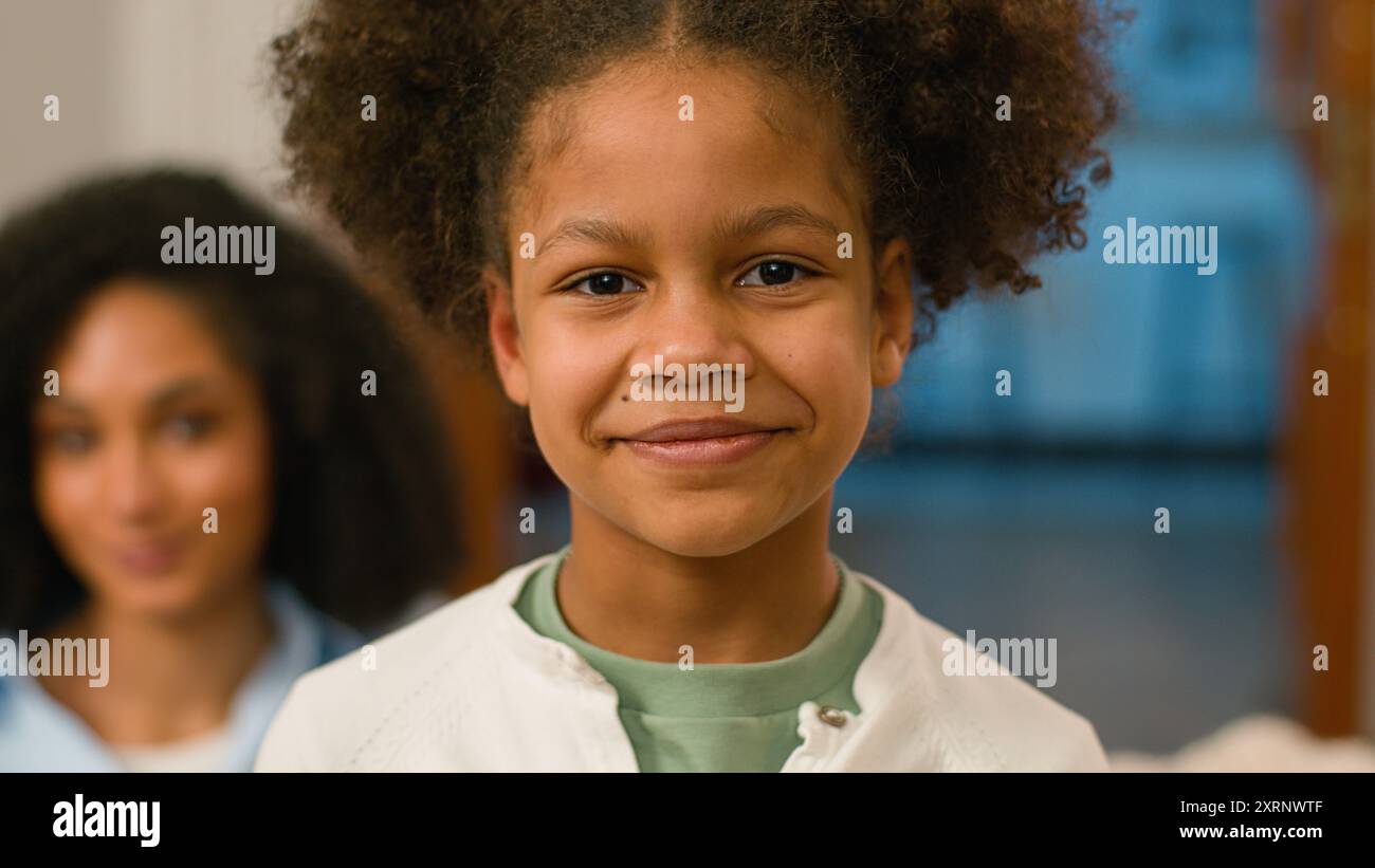 Close up face African American child little girl smile laughter ...
