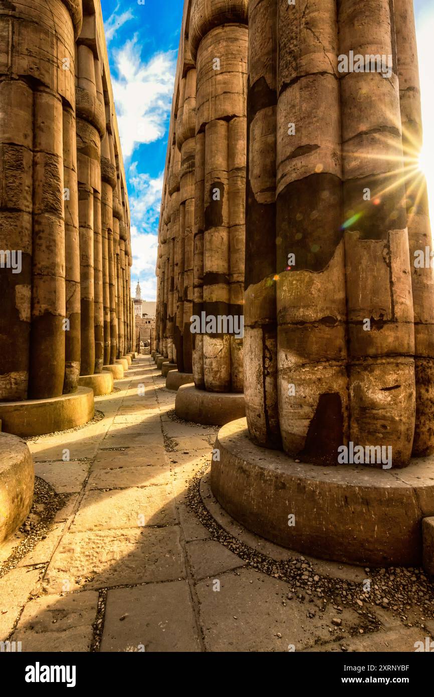 Sun rising behind the open-flower papyrus columns of the Colonnade of ...