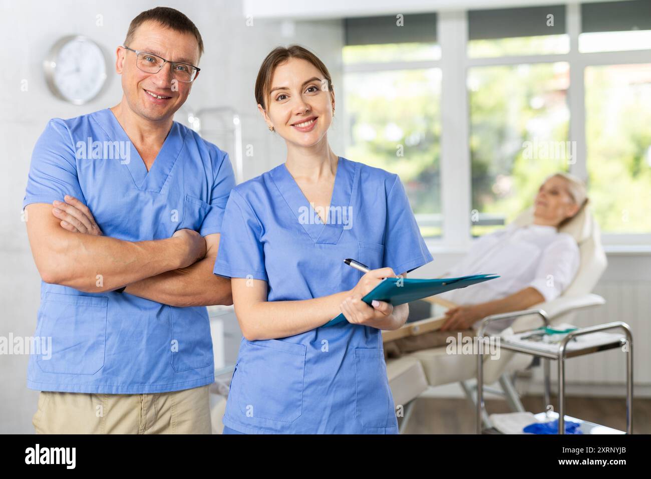 Portrait of two doctors - man and woman in the interior of clinic Stock ...
