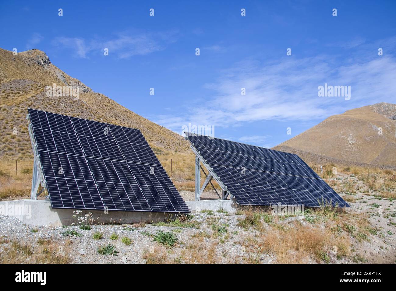 Solar panels are installed on a mountainside next to the road ...