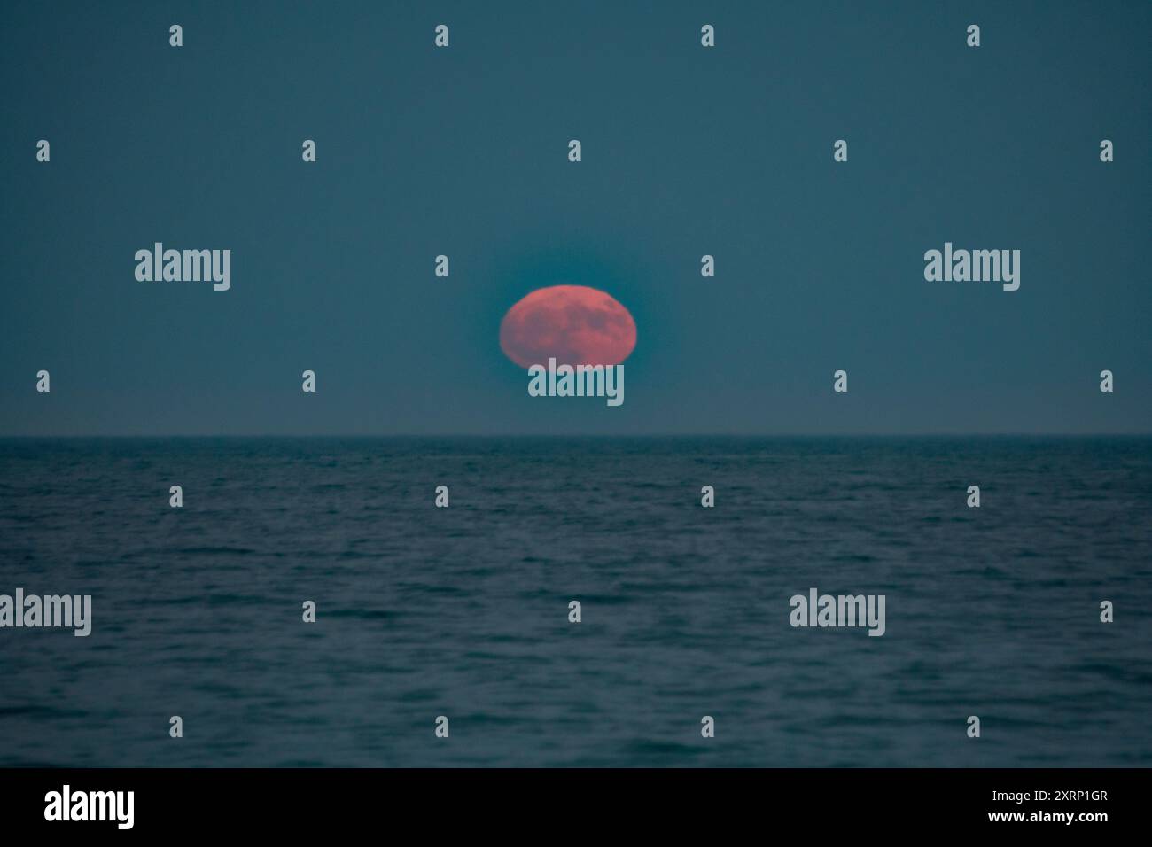 Full moon rises over the Atlantic Ocean Stock Photo - Alamy