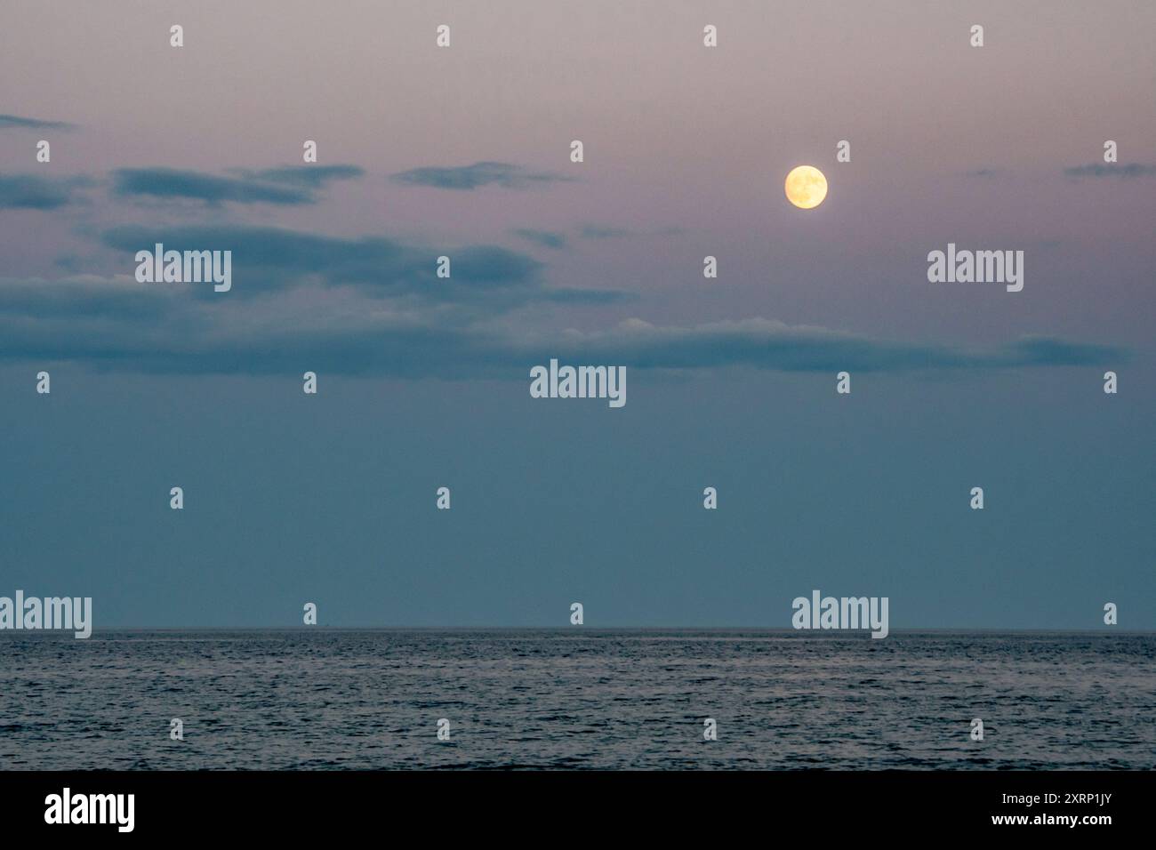 Full moon rises over the Atlantic Ocean Stock Photo - Alamy