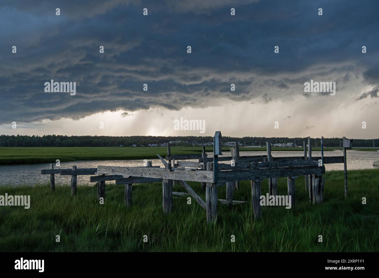 Weathered dock near estuary with incoming storm clouds Stock Photo - Alamy