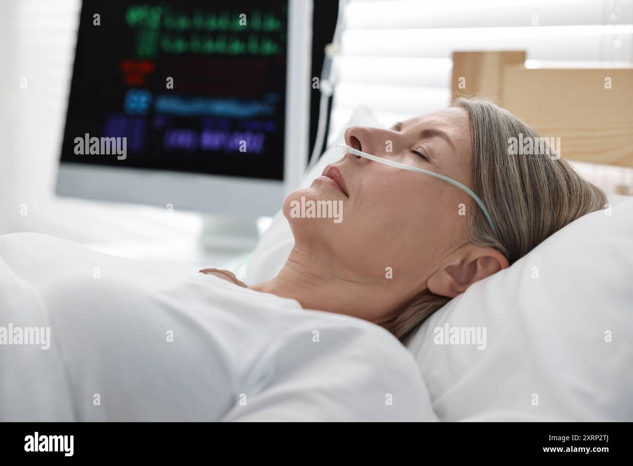 Coma patient. Mature woman sleeping in hospital bed Stock Photo - Alamy