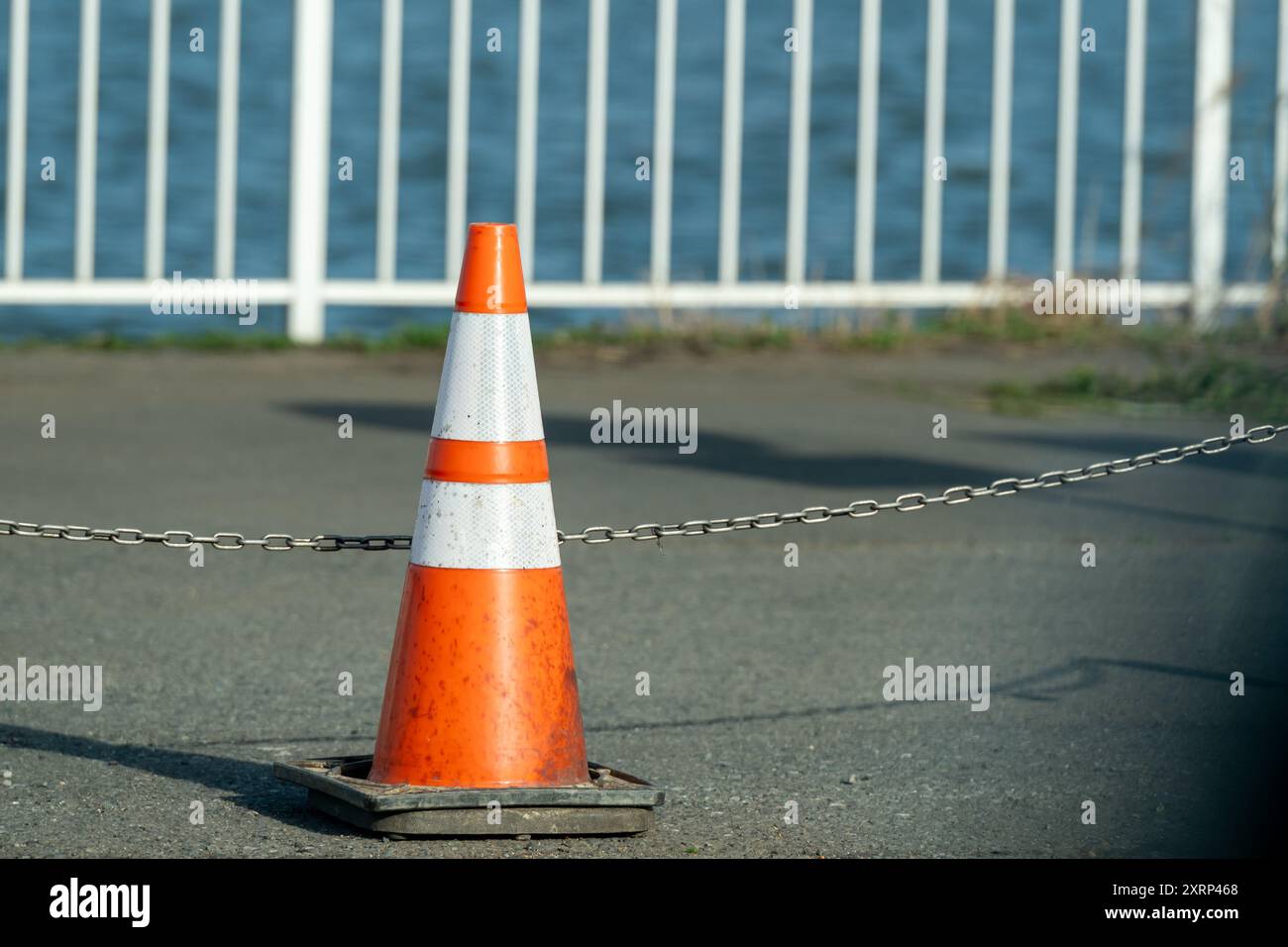 An old traffic cone sign with metal chain Stock Photo - Alamy