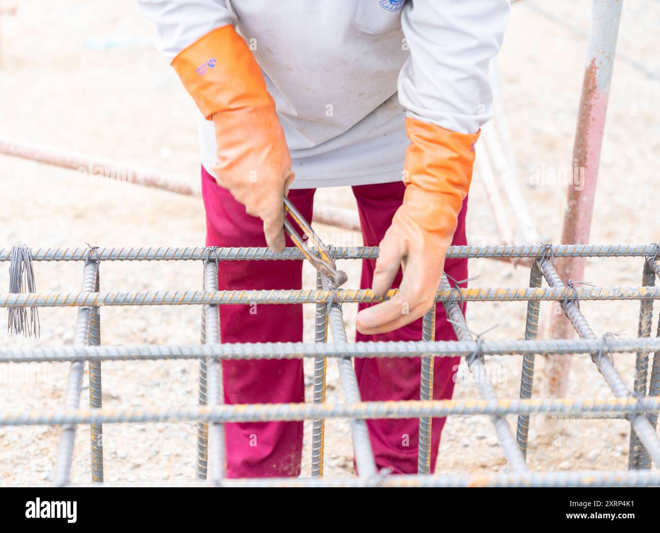 Worker use pliers bundle reinforcement deformed bar at construction ...
