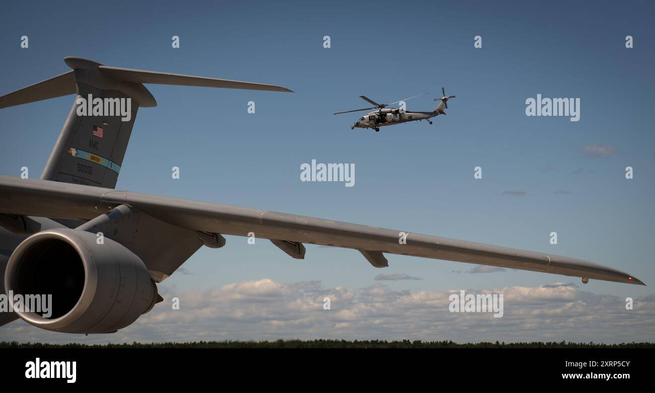 An H-60 Seahawk flies overhead while U.S. Air Force, Air National ...