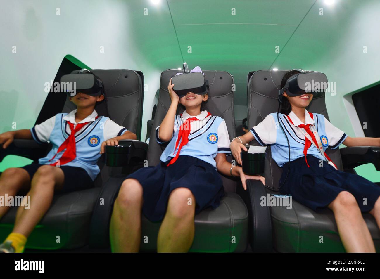 QINGDAO, CHINA - AUGUST 11, 2024 - Primary school children experience a VR4D image of high-speed ...