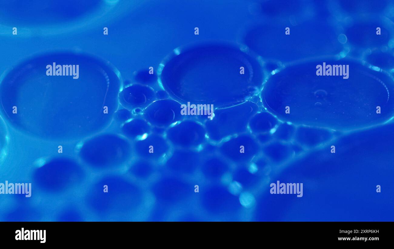 Fizzy liquid. Oil fluid. Blur blue color transparent paint water round ...