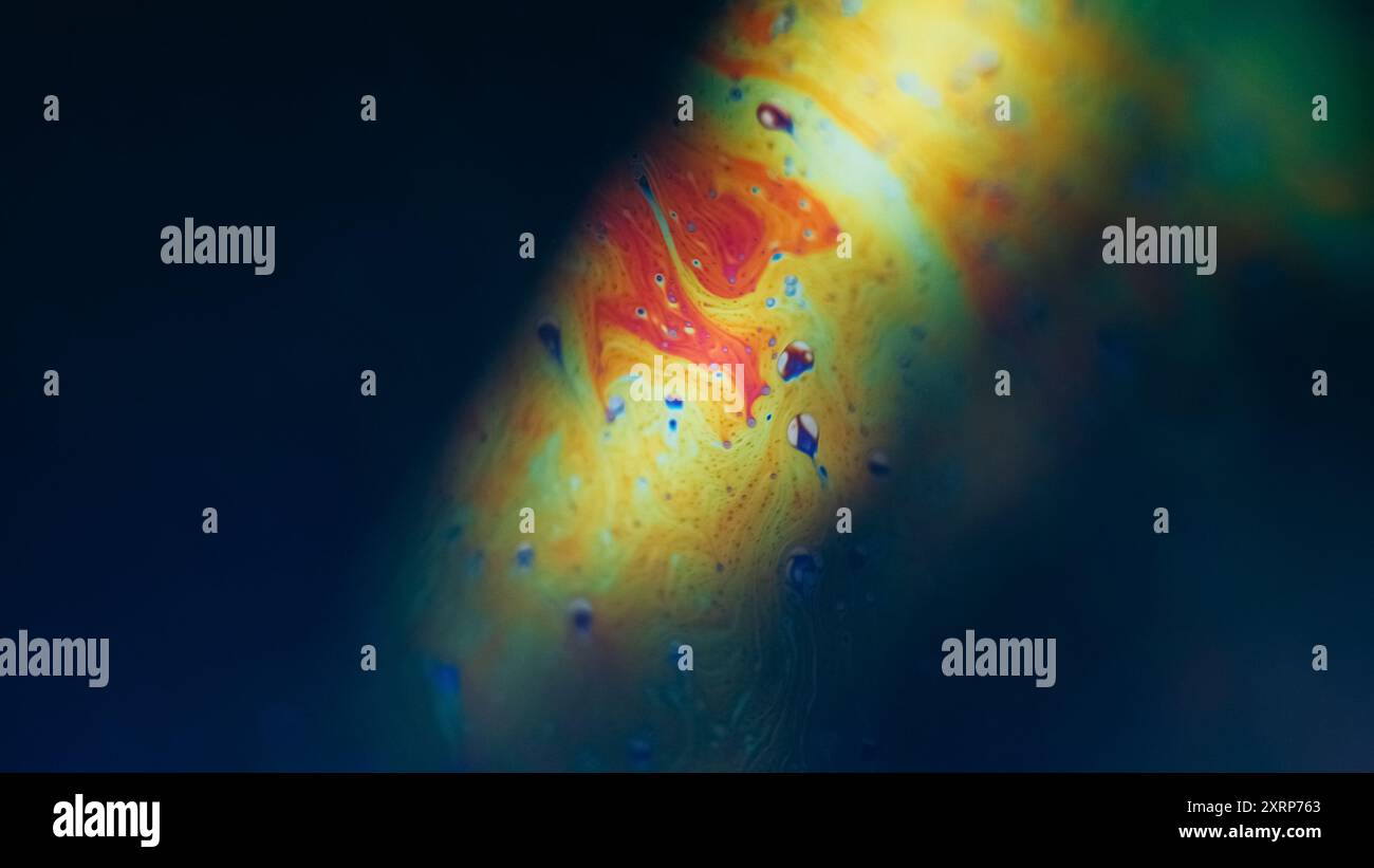 Ink rainbow. Psychedelic fluid. Defocused yellow blue green color oil ...