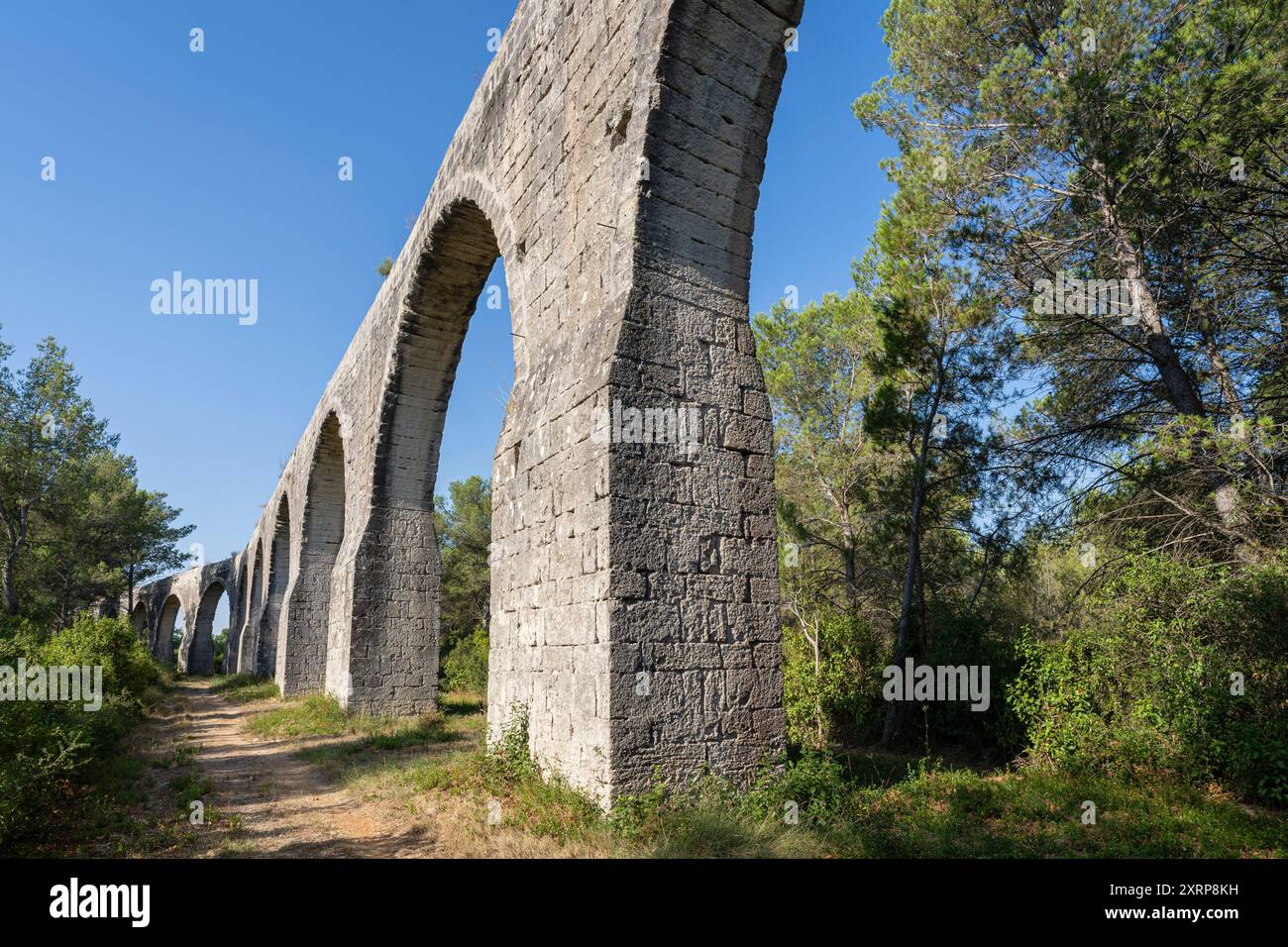 Landscape perspective view of ancient stone aqueduct, famous historic ...