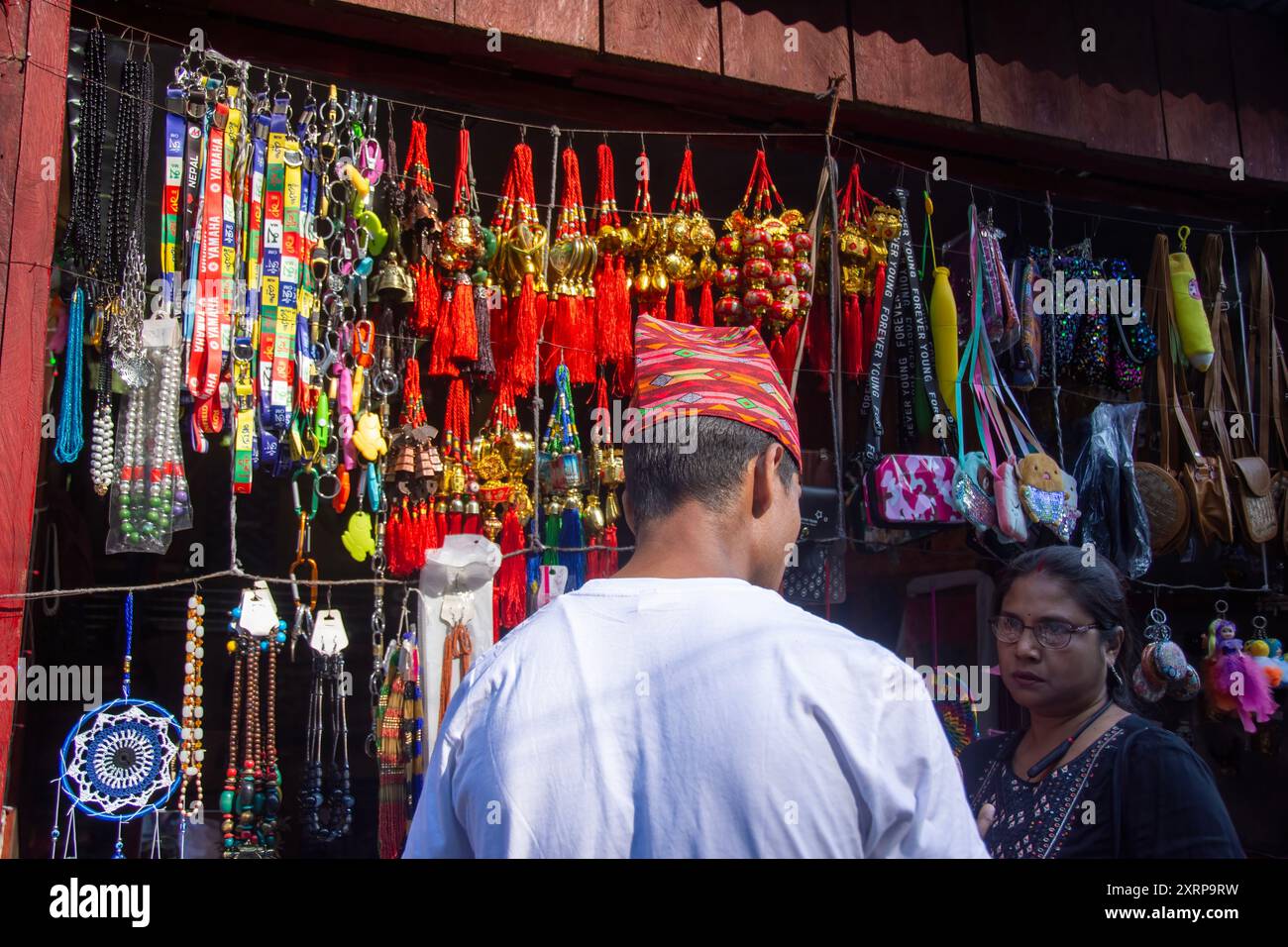 a Nepali shop owner convincing a lady customer Stock Photo - Alamy