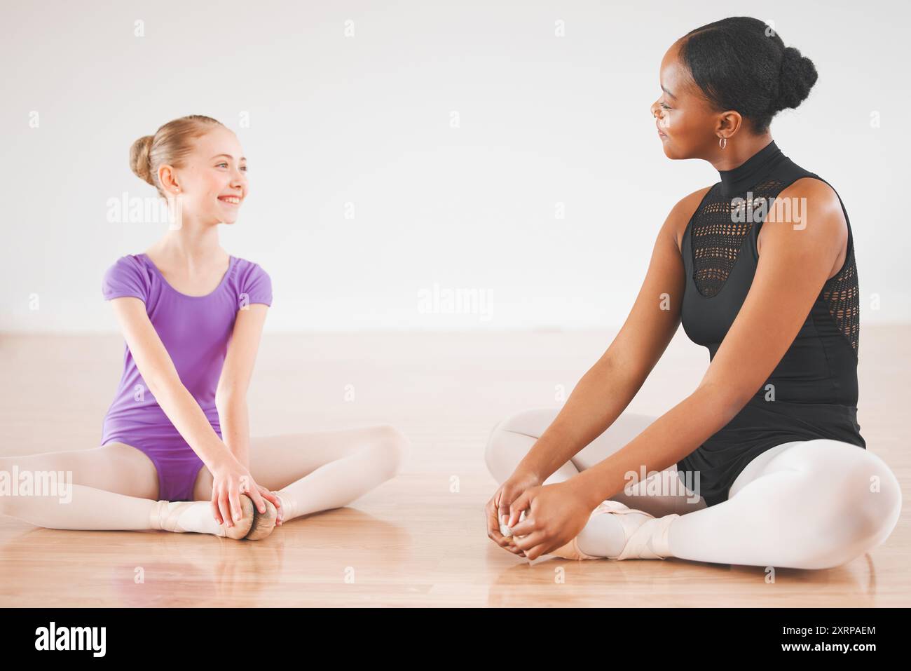 Ballet, student and woman with stretching in studio on floor for dance ...