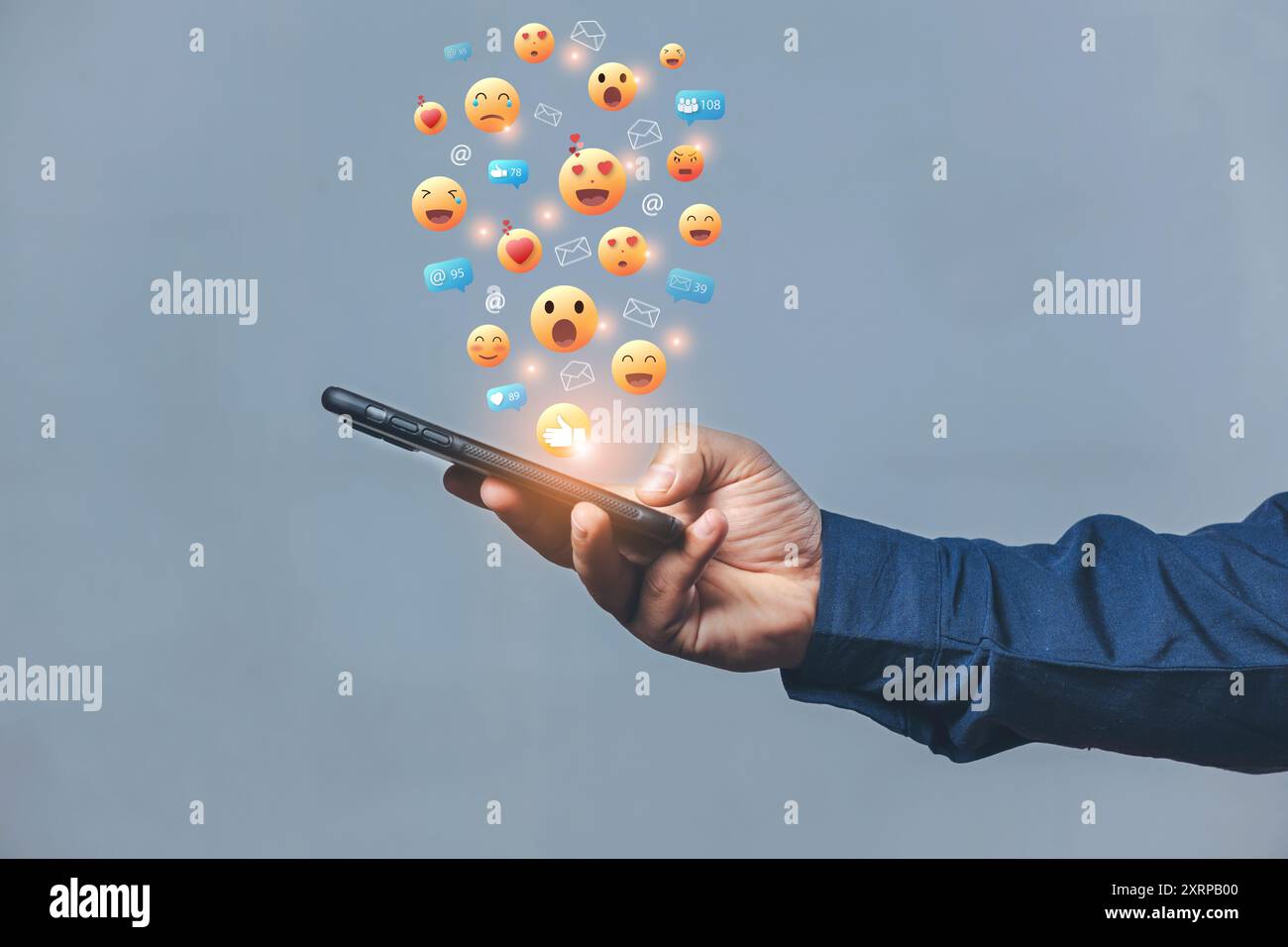 Hands holding and typing to communicate with others through emoji ...