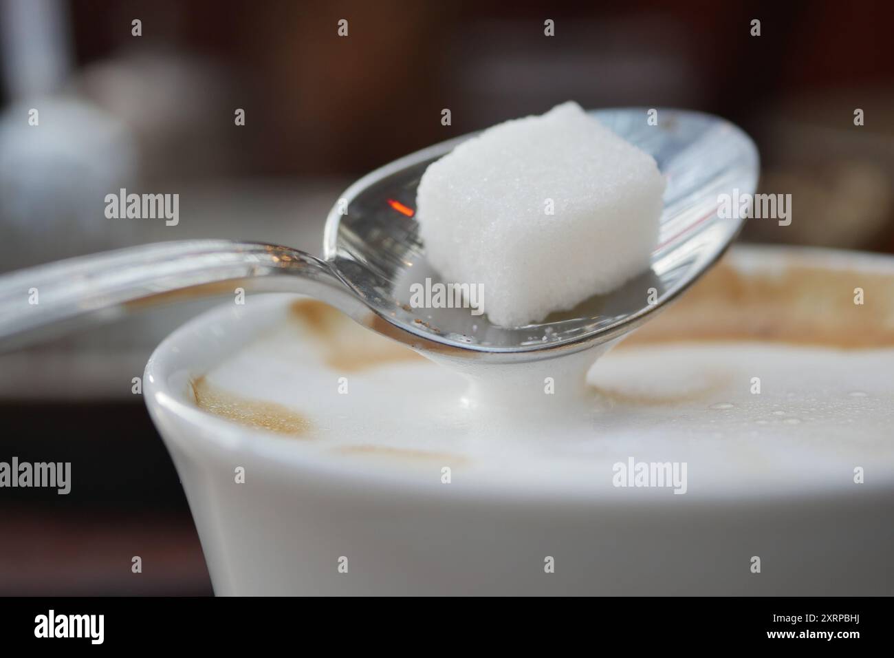 pouring white sugar cube in a coffee cup Stock Photo - Alamy