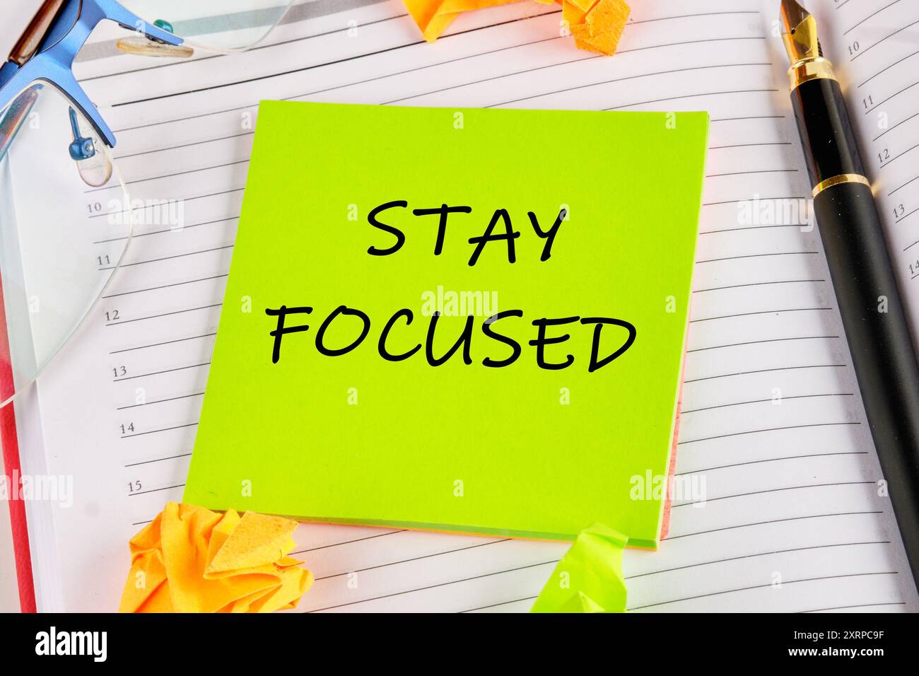 STAY FOCUSED text on a light green sticker lying on the notebook Stock ...
